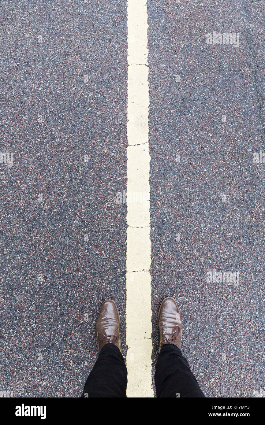 Casual woman shoes standing over the white line that separate left and ...
