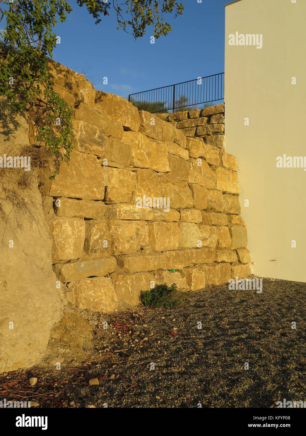 Retaining wall from square granite blocks in residential area ...