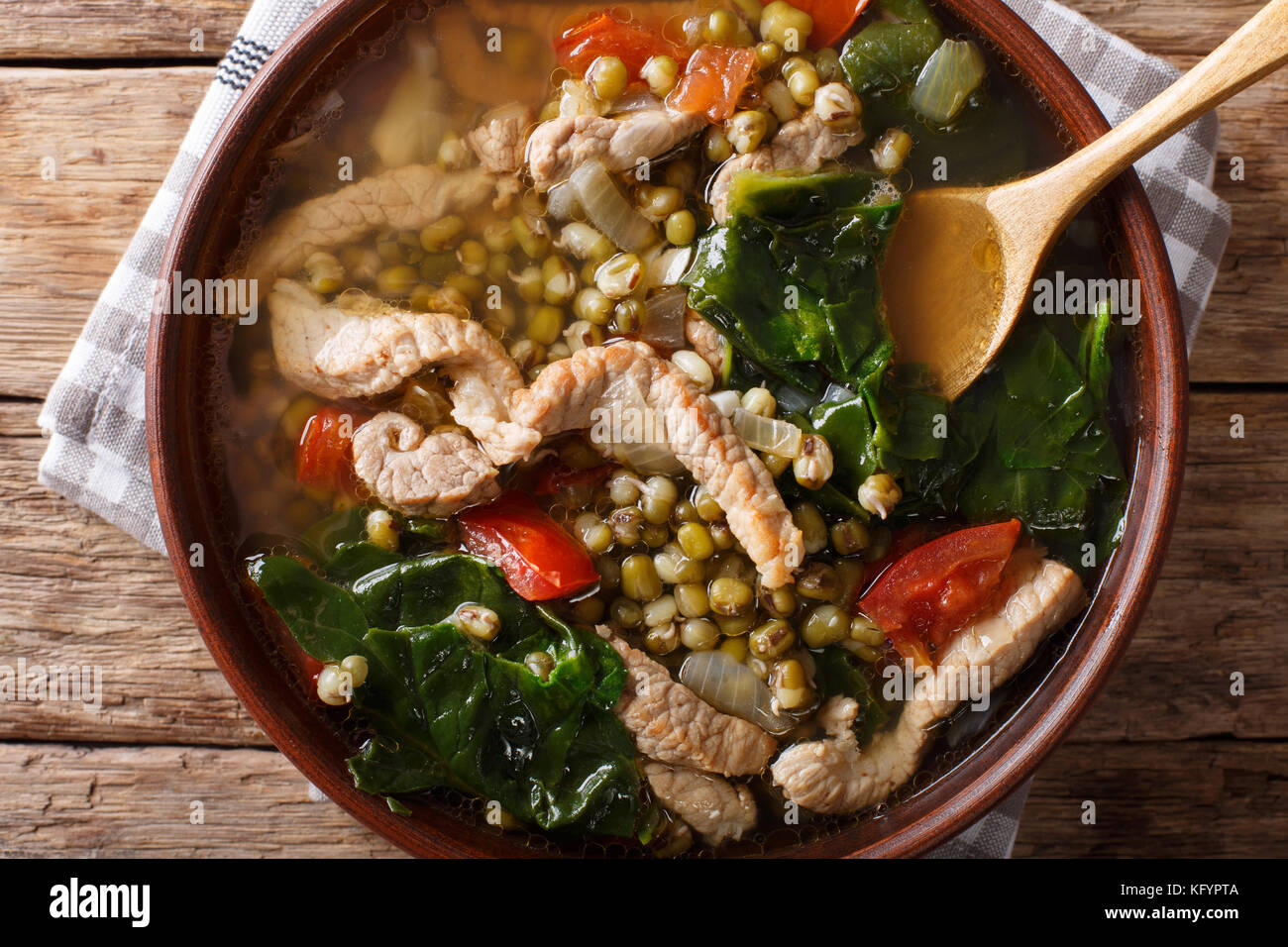 Filipino Mungo Guisado (Mung Bean Soup) close-up in a bowl on the table ...