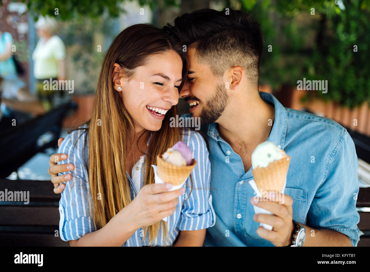 Happy couple having date and eating ice cream Stock Photo - Alamy