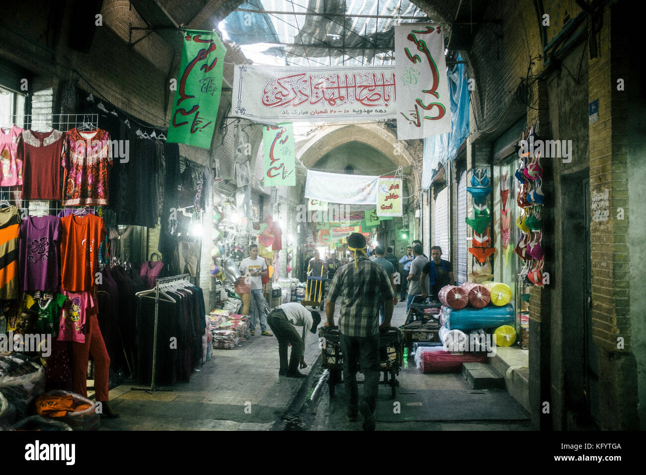 Tehran, Iran - June 7, 2015. Clothing shops, salesmen and workers doing ...