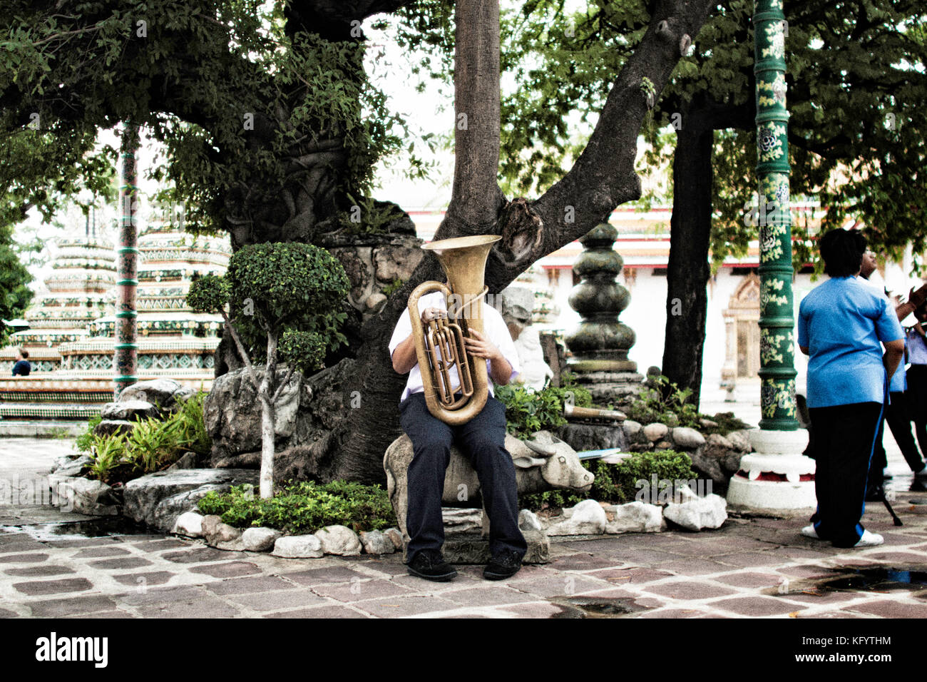 Bangkok, Thailand - July 30, 2012. A street musician is playing the ...