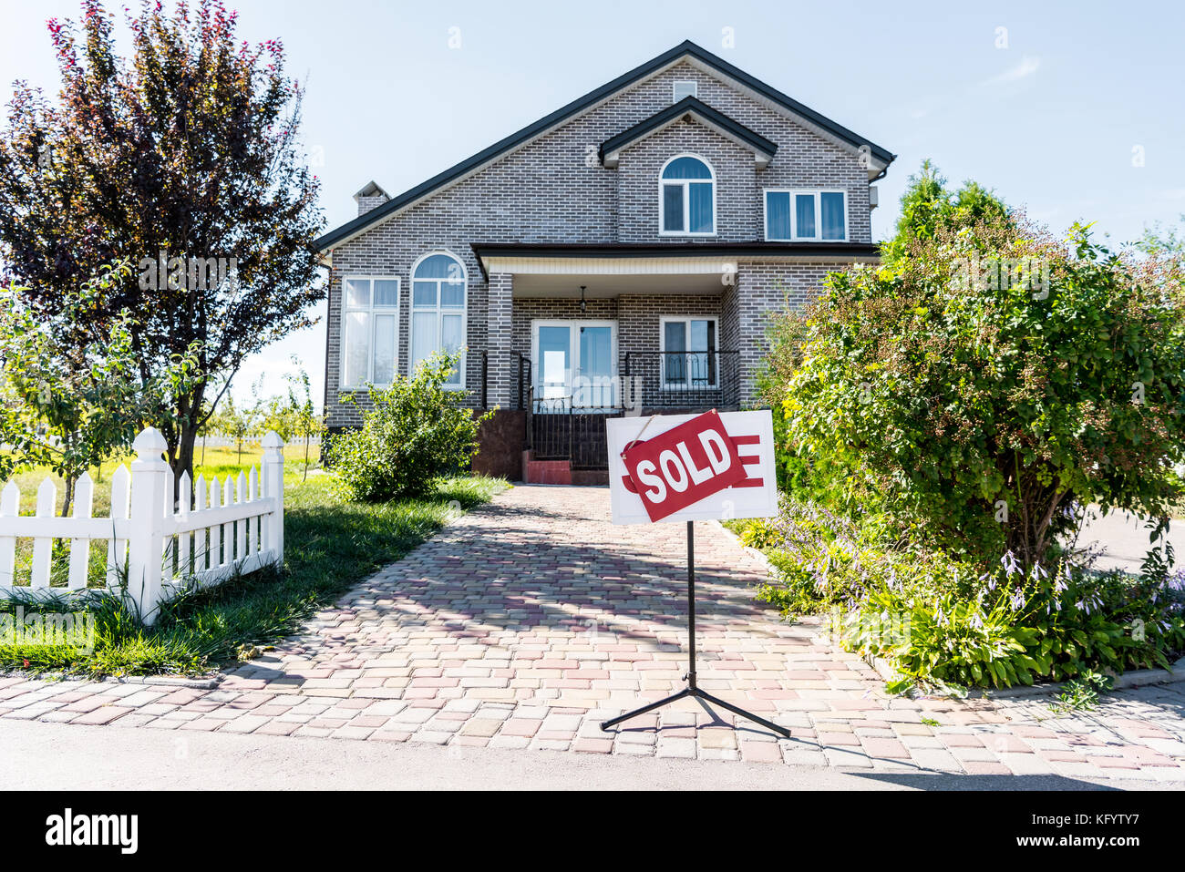 house with sign sold Stock Photo - Alamy