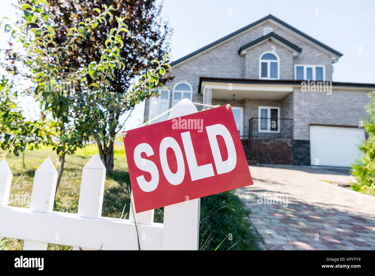 house with sign sold Stock Photo - Alamy