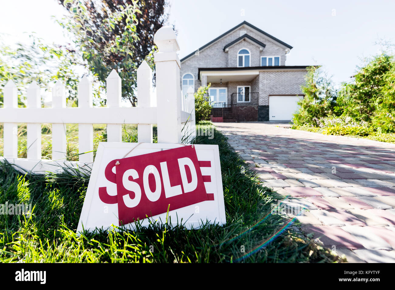 house with sign sold Stock Photo - Alamy