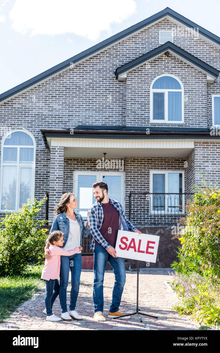 Family standing in front of house hi-res stock photography and images ...