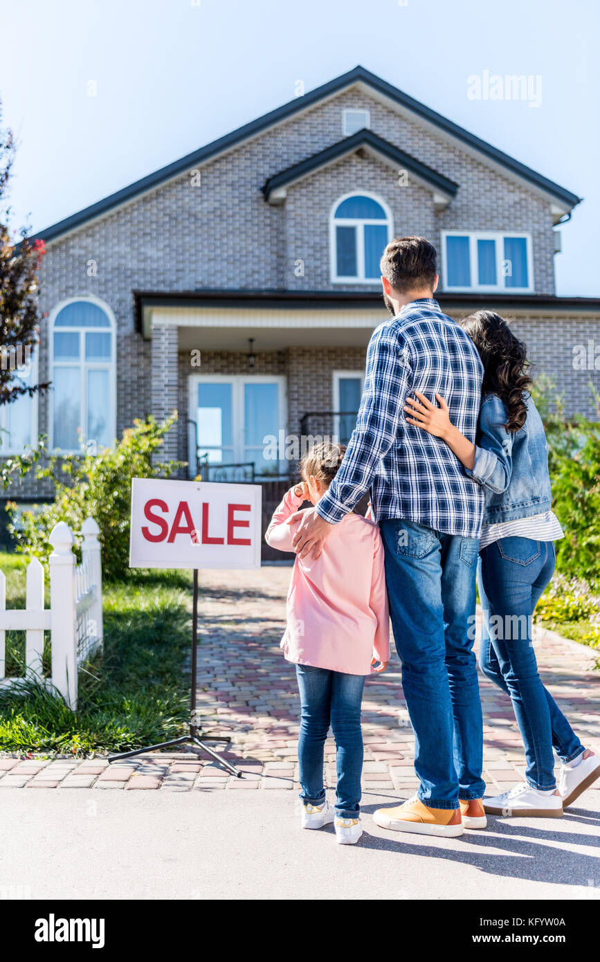 family looking at house on sale Stock Photo - Alamy