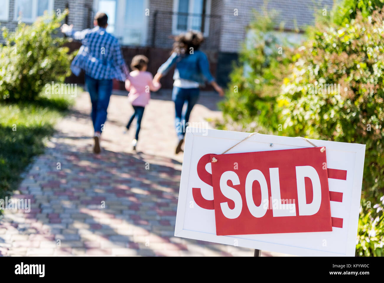 family running to new house Stock Photo - Alamy