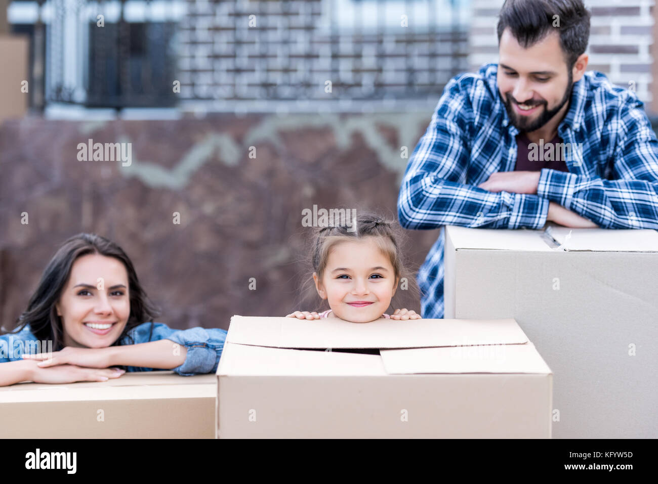 young family with boxes Stock Photo - Alamy