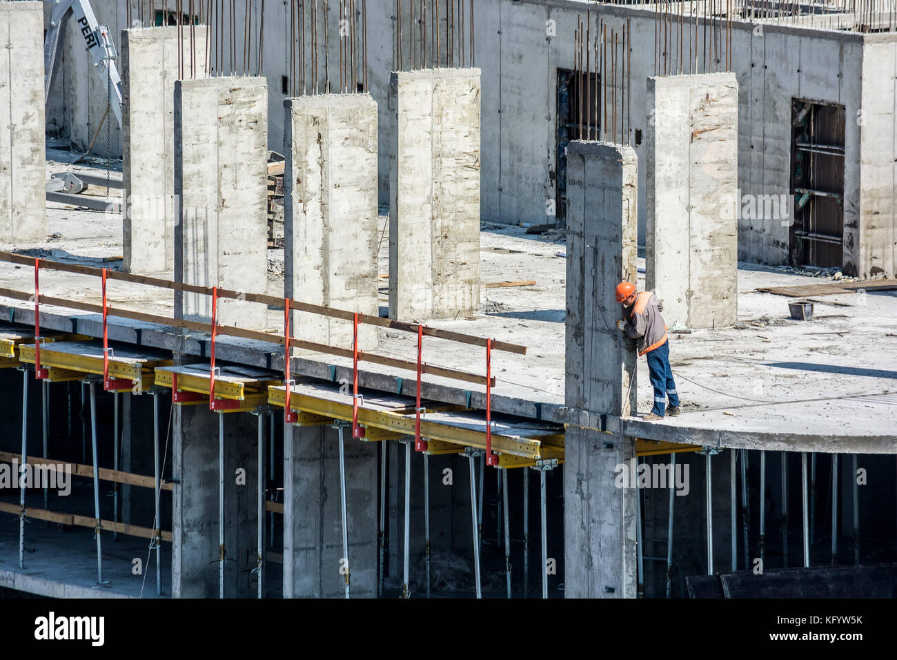 Close up of construction site of new concrete building and people ...