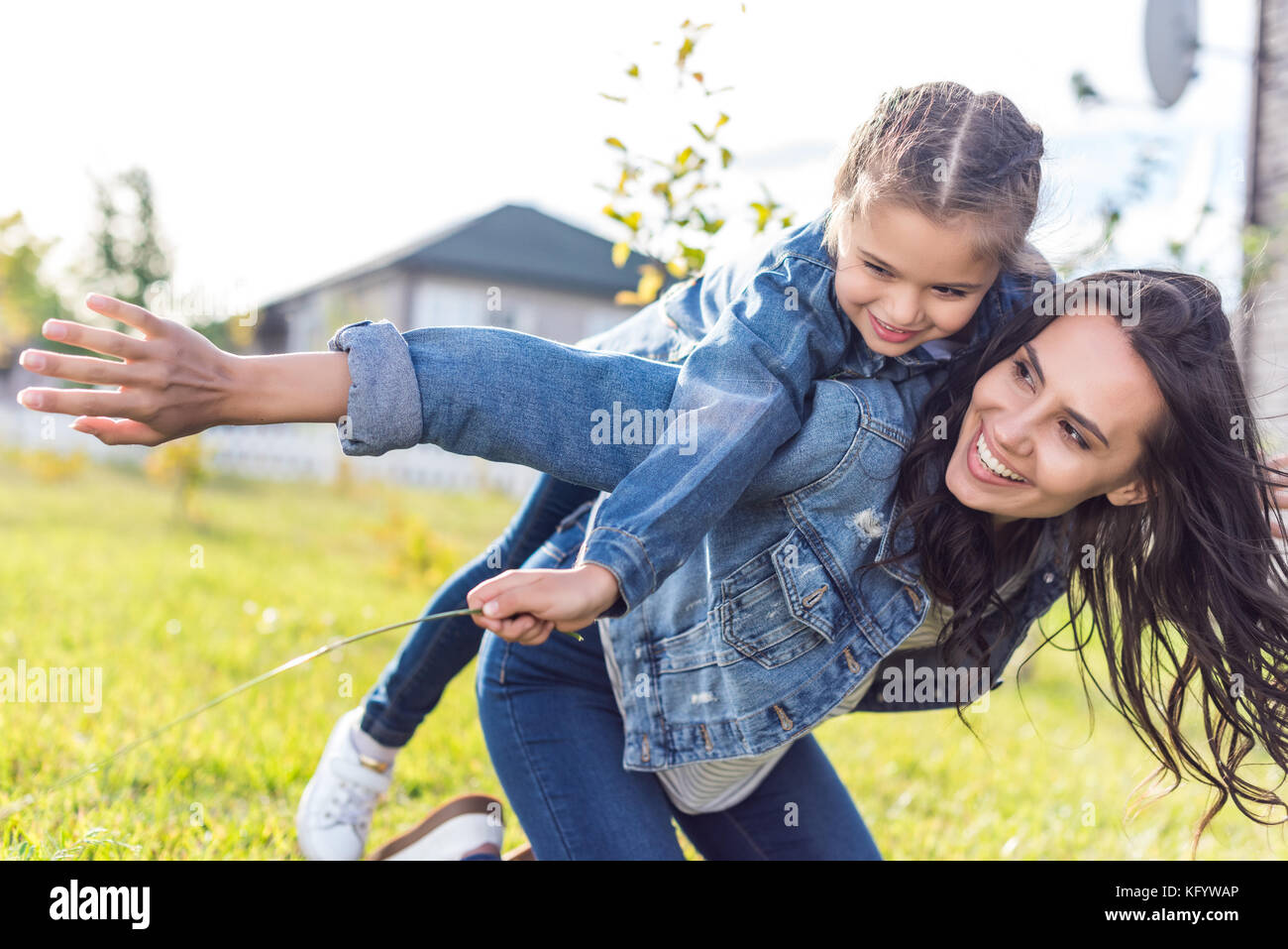 Daughter piggyback riding mother hi-res stock photography and images ...