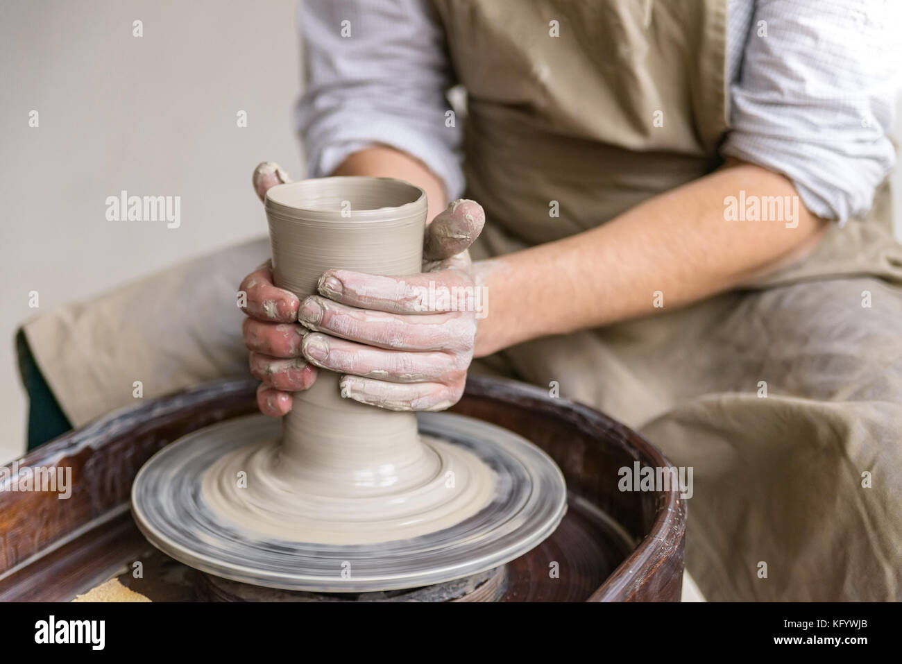 Hands working on pottery wheel Stock Photo - Alamy