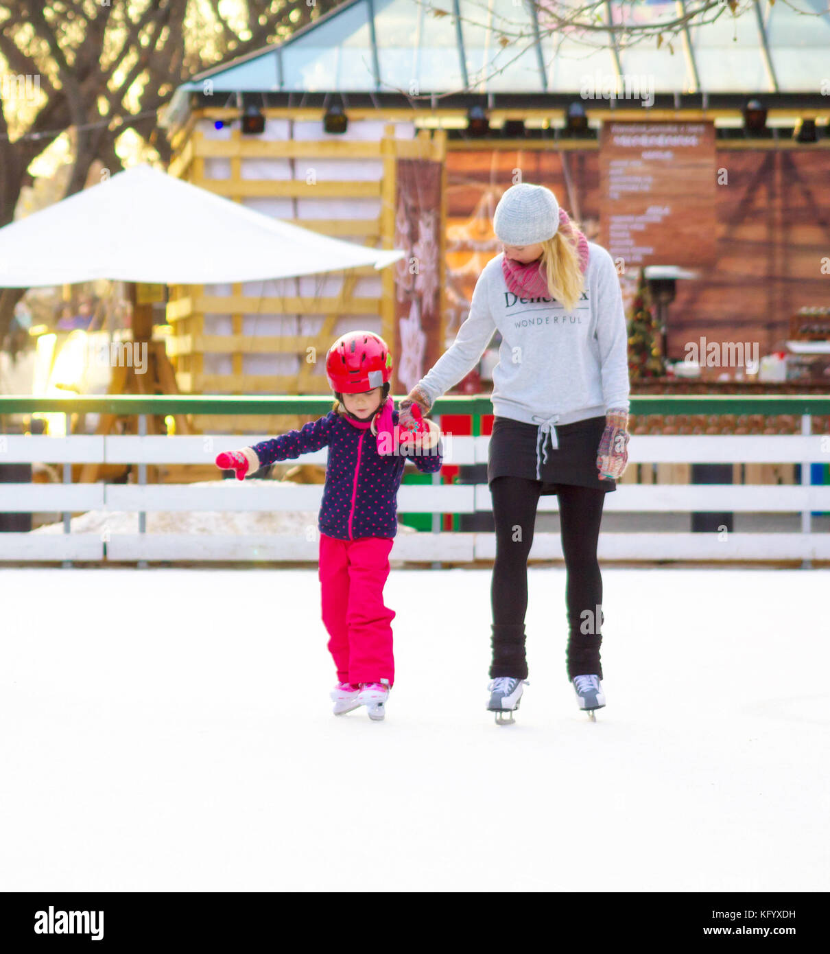 A Young Mother with her child on ice-skating rink Stock Photo - Alamy