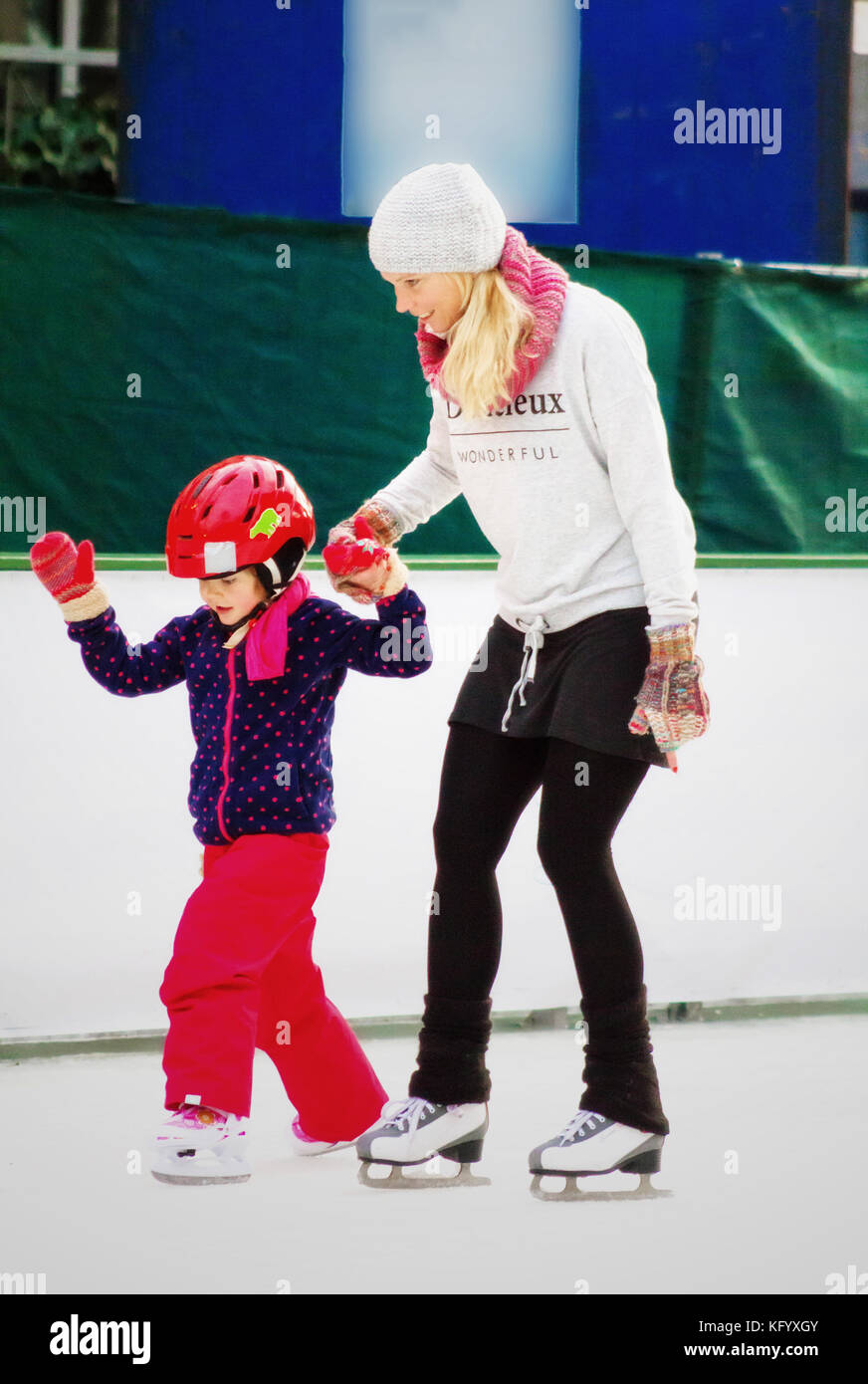 A Young Mother with her child on ice-skating rink Stock Photo - Alamy