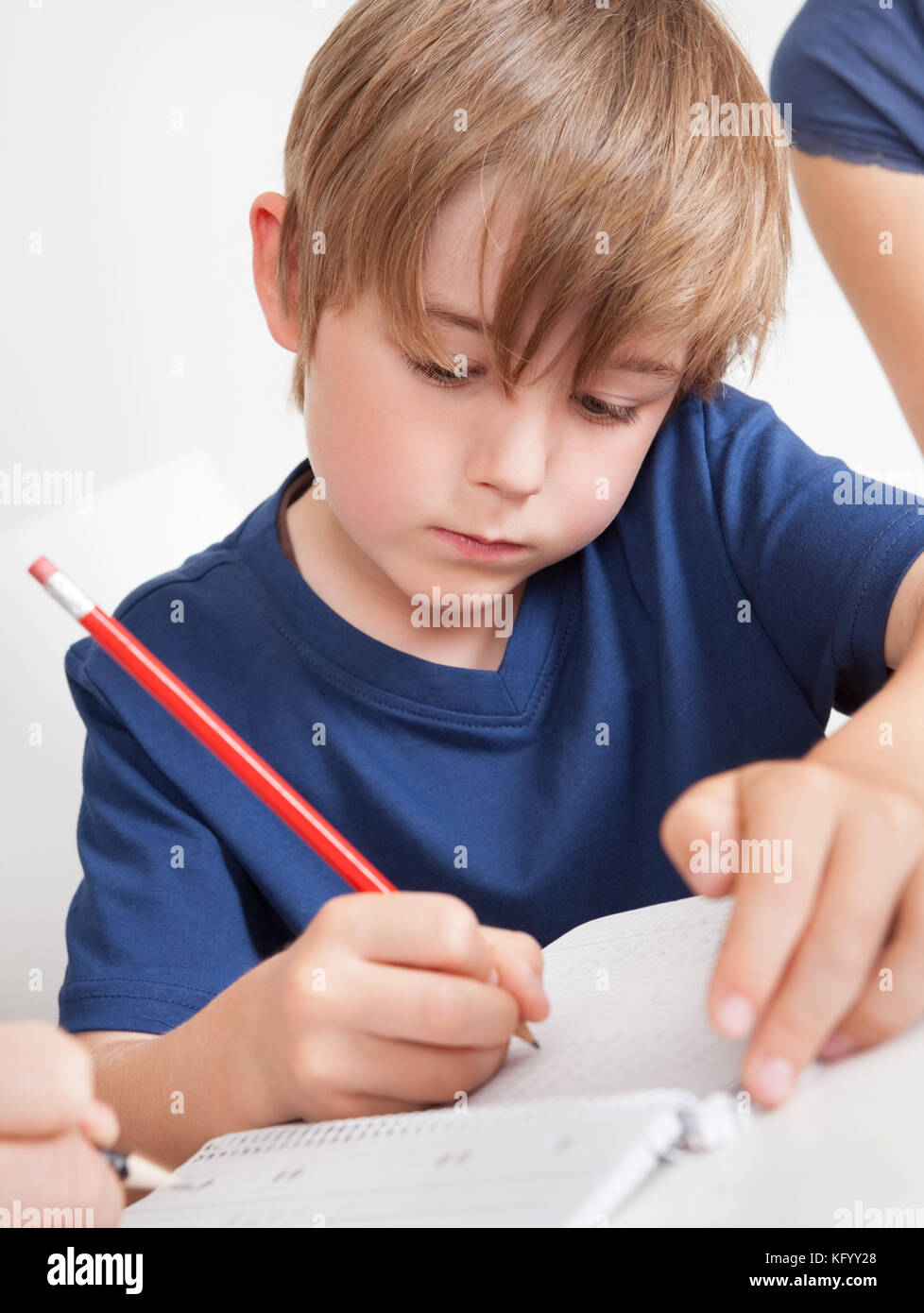 Portrait of young boy doing homework at home Stock Photo - Alamy