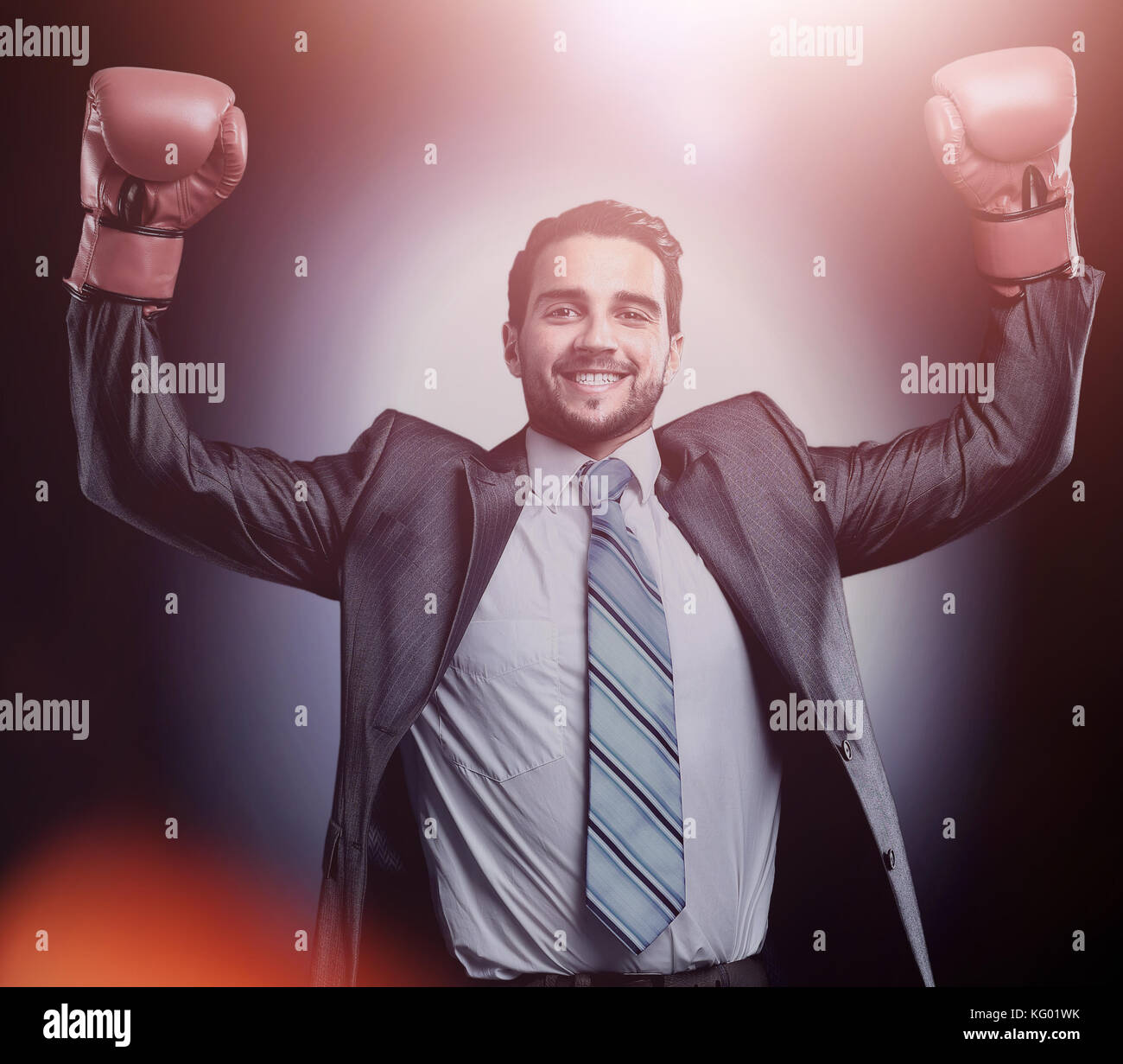 Businessman in a suit and boxing gloves, celebrating a win Stock Photo ...