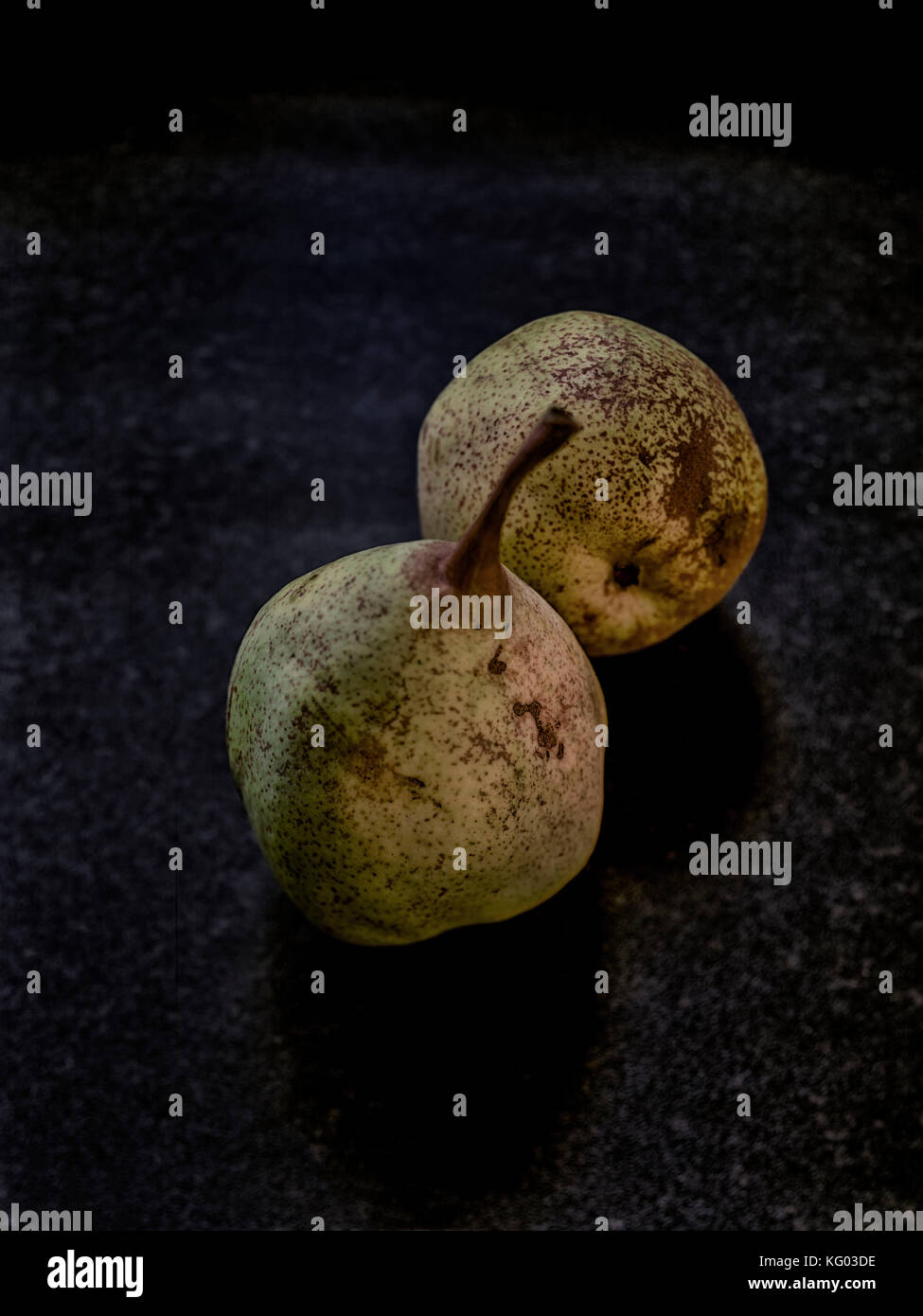 Windfall pears on dark background Stock Photo - Alamy