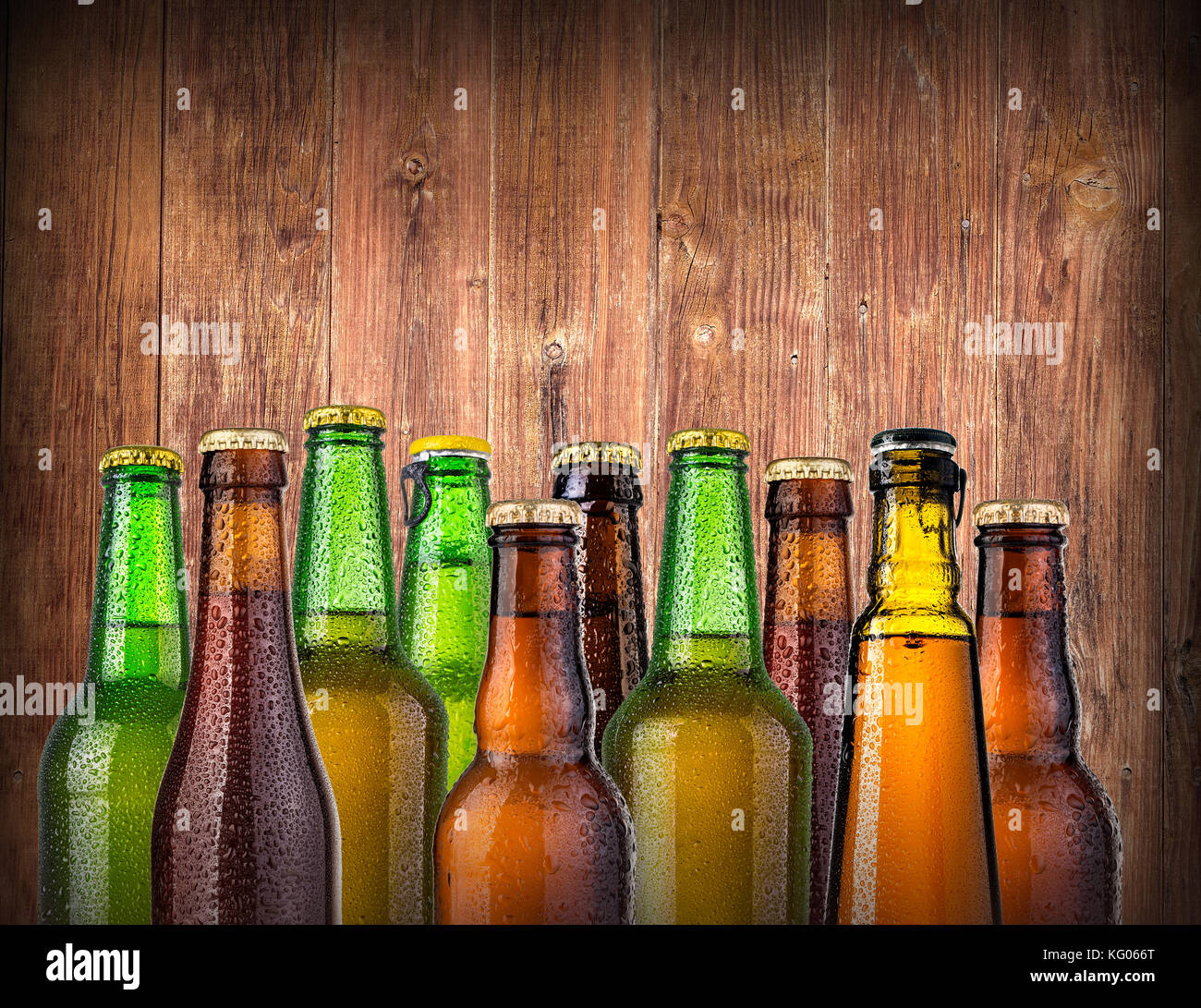 beer bottles on wooden texture background Stock Photo - Alamy