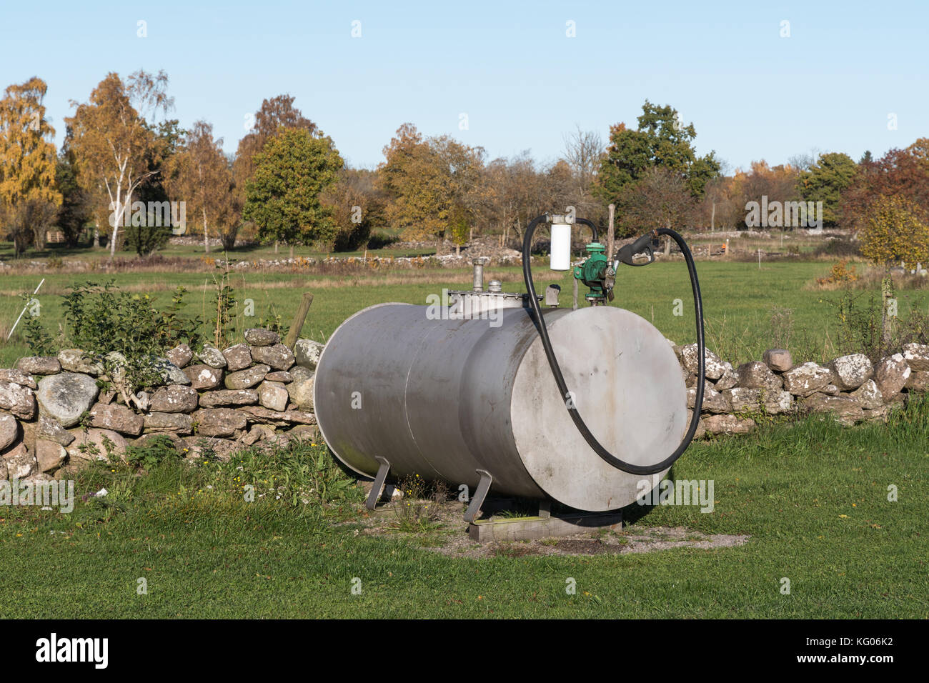 Farmers fuel tank outdoors in a landscape by a stone wall Stock Photo ...