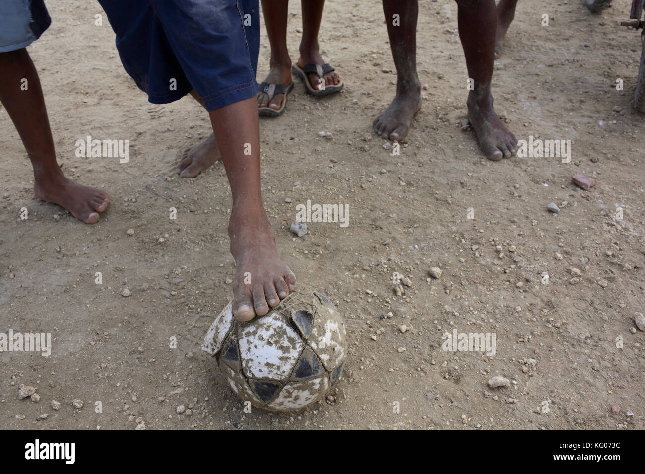Bare feet of young Colombian children with a football Stock Photo - Alamy