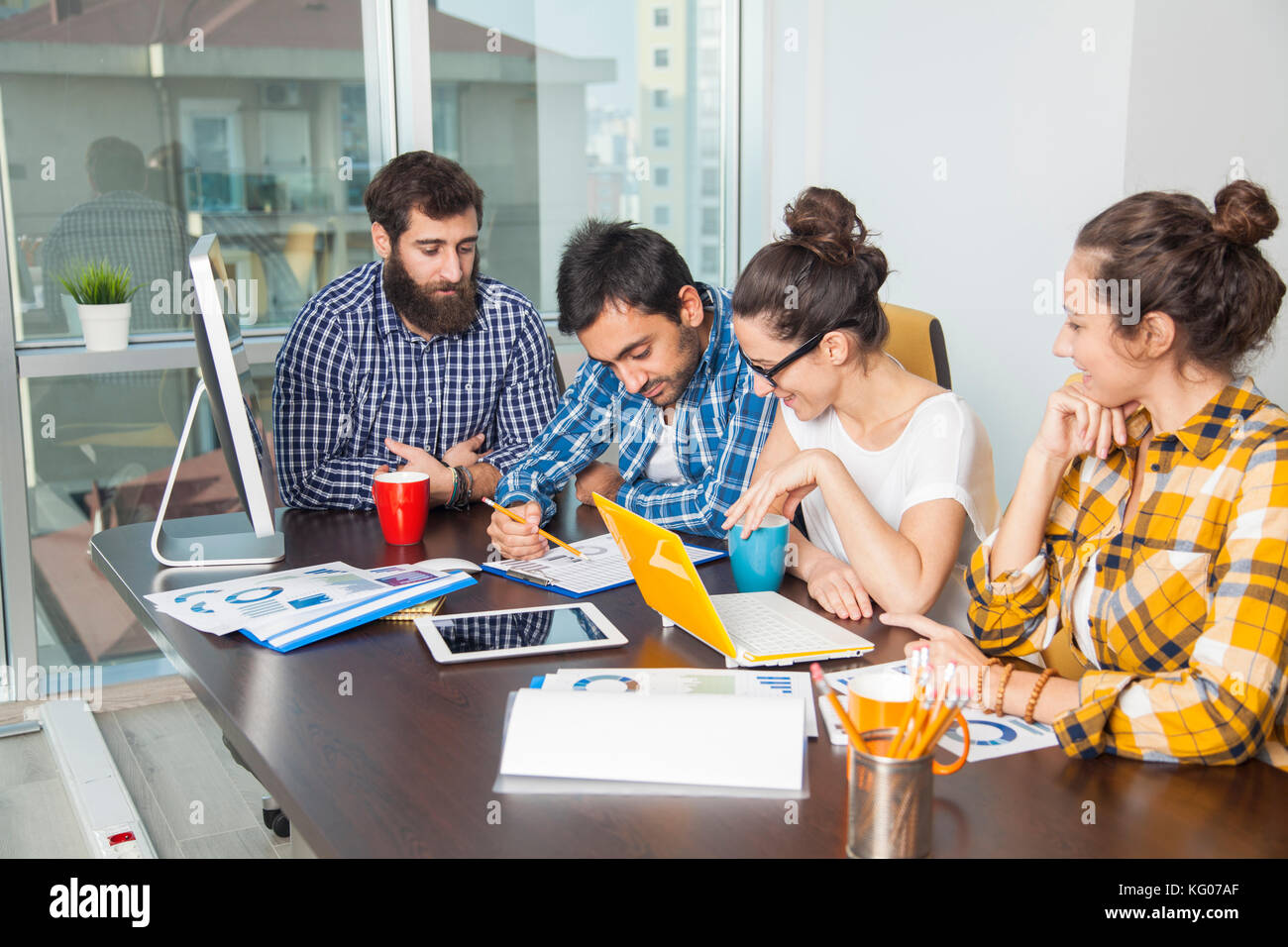 Business team working at a desk on computers Stock Photo - Alamy