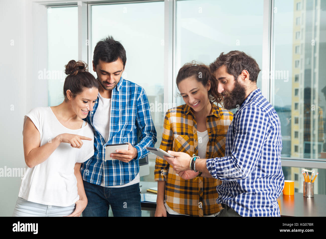 Group of young business people with technology Stock Photo - Alamy