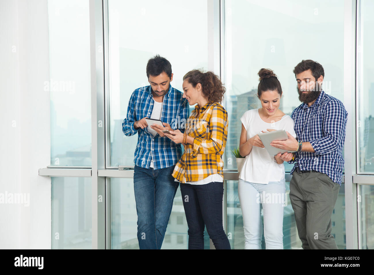 Group of young business people with technology Stock Photo - Alamy