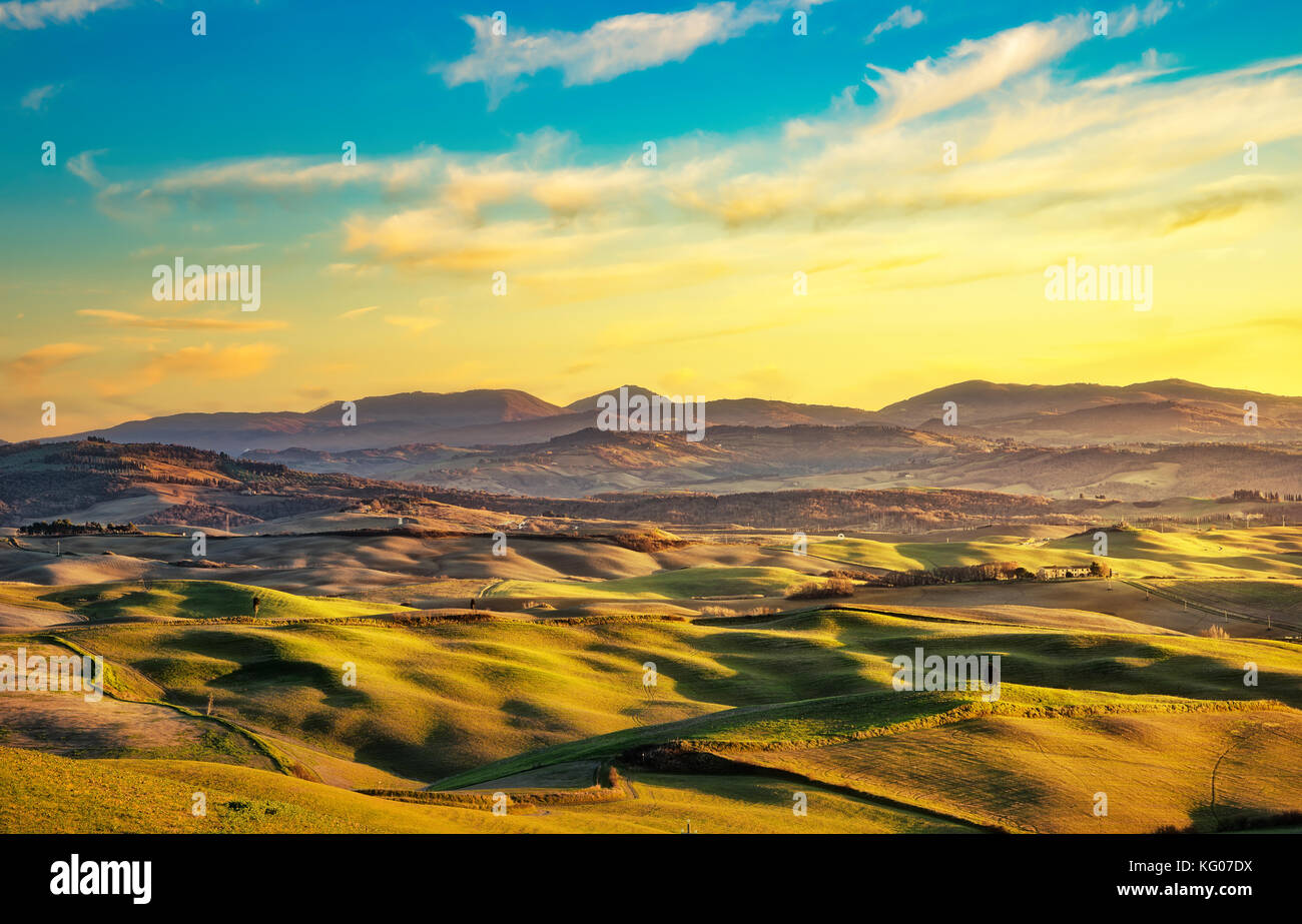 Volterra winter panorama, rolling hills and green fields on sunset ...