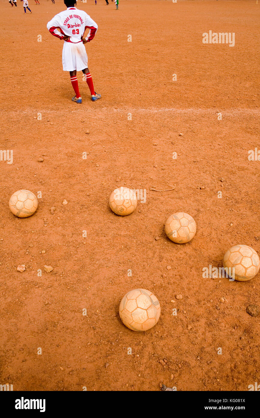 Footballs covered in red dust Stock Photo - Alamy