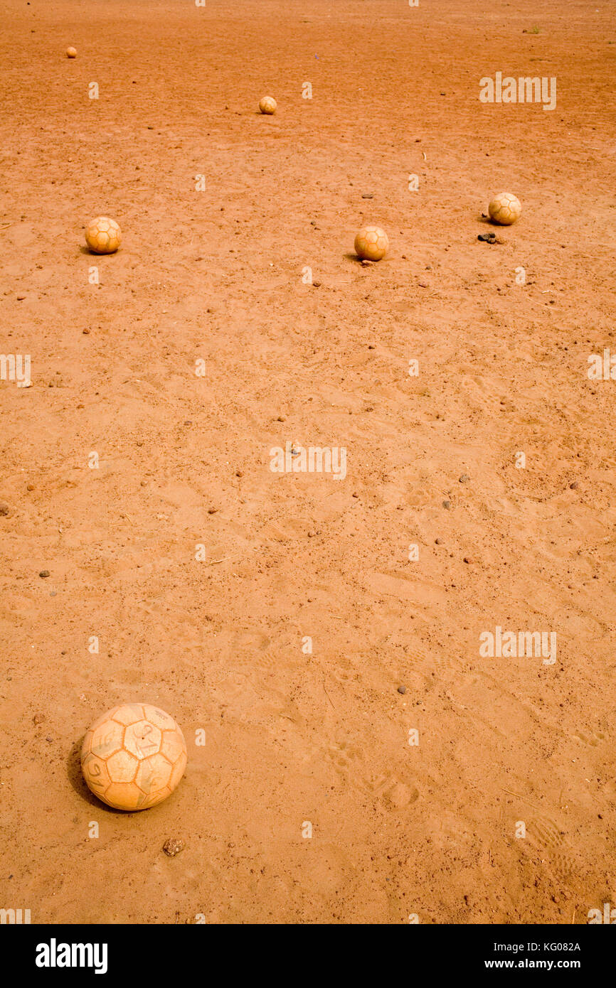 Footballs covered in red dust Stock Photo - Alamy