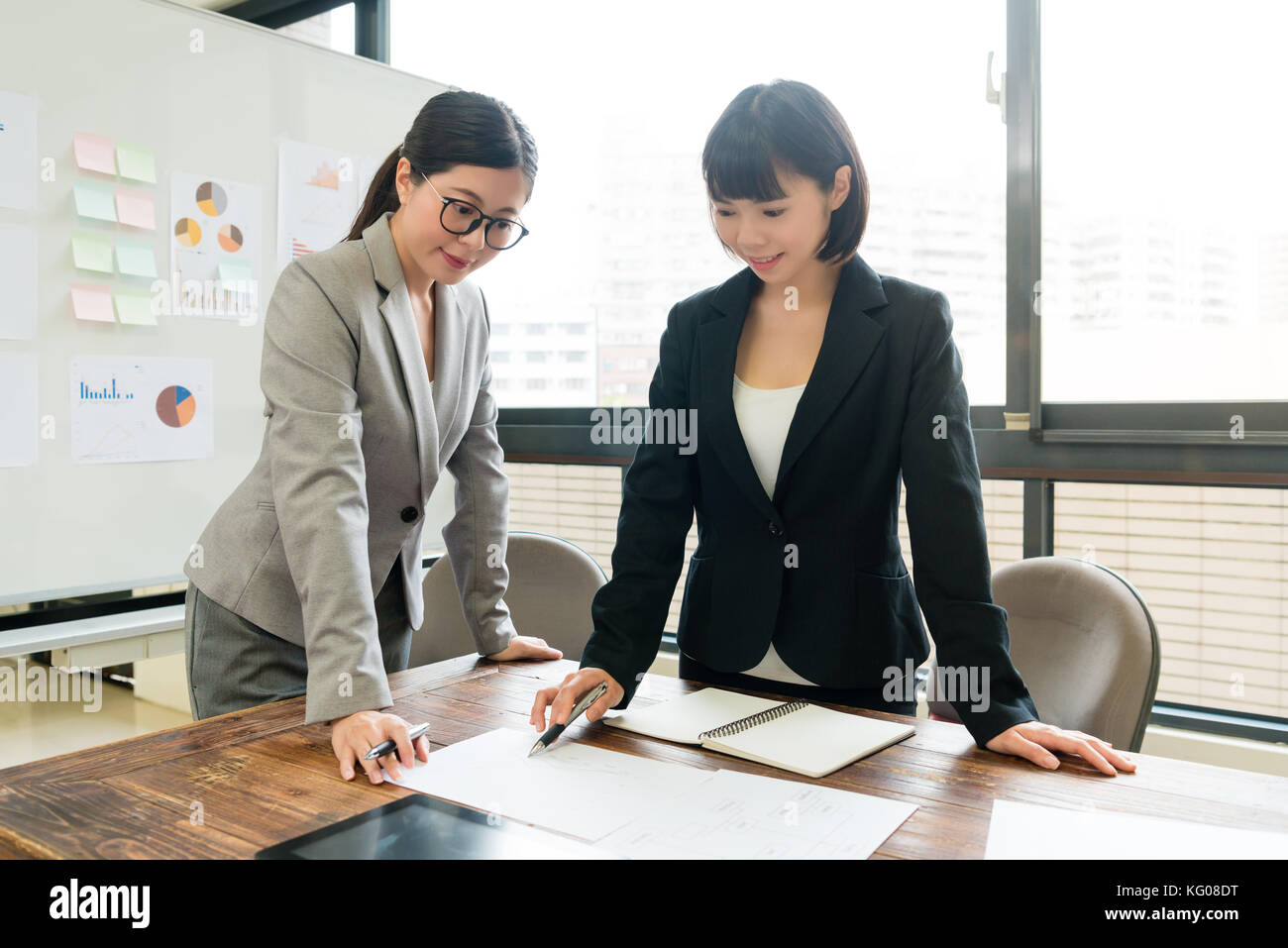 beautiful young office worker girl presenting company marketing ...