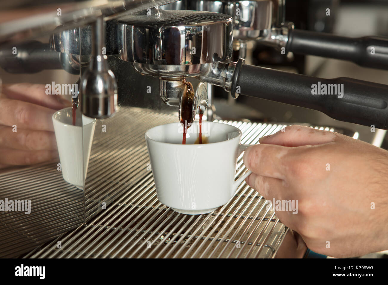 Close-up of espresso pouring from coffee machine Stock Photo - Alamy