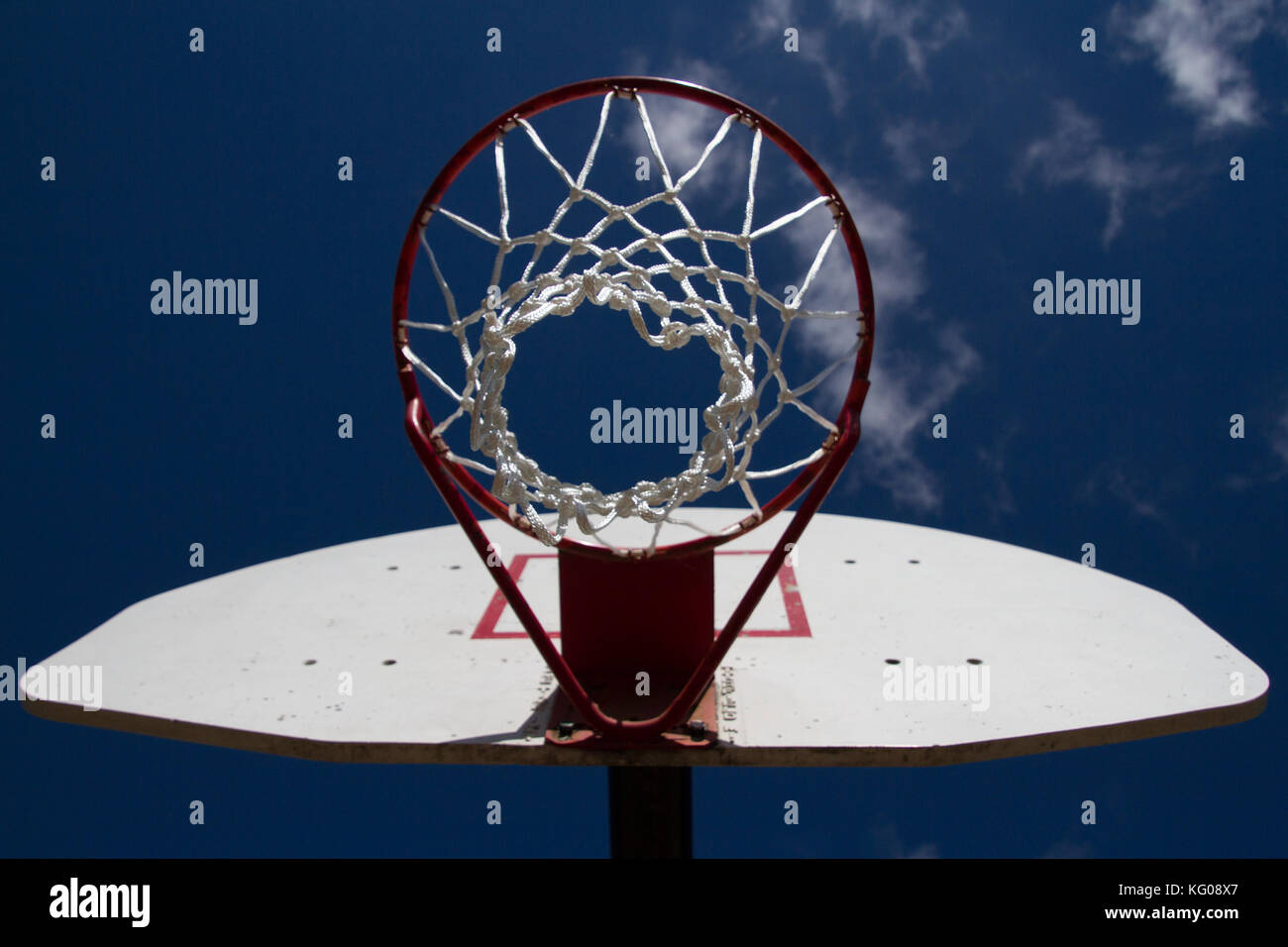 Looking up through a basketball hoop at the blue sky Stock Photo - Alamy