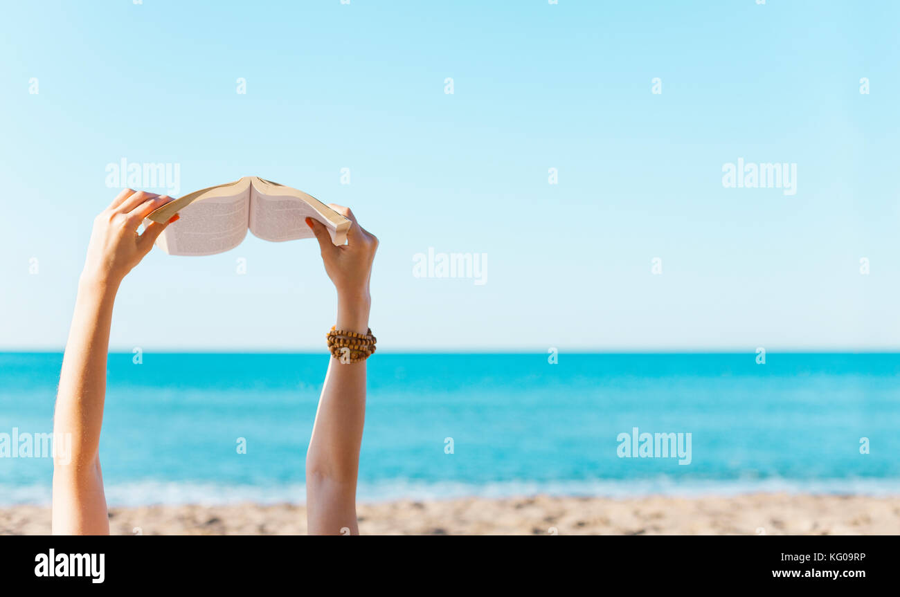 Hands holding book hi-res stock photography and images - Alamy
