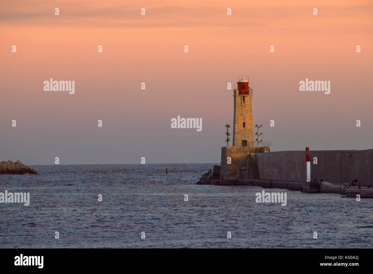 Nice harbor lighthouse at sunset Stock Photo - Alamy