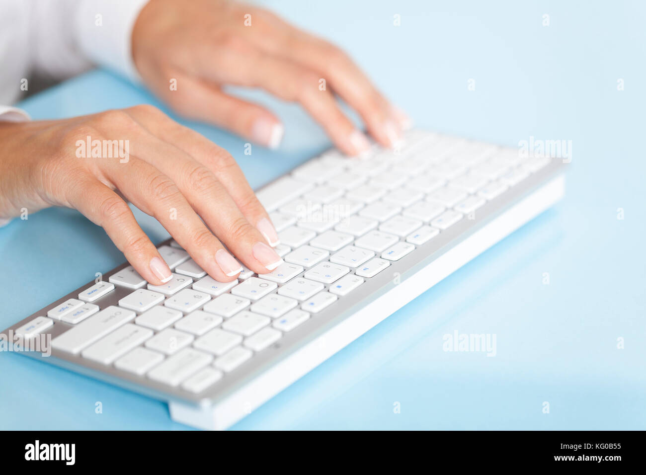 Close-up of business woman's hands touching computer keys during work ...