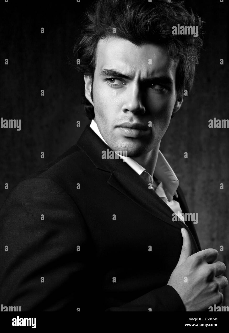 Confident ambitious handsome man with strained look posing in fashion ...