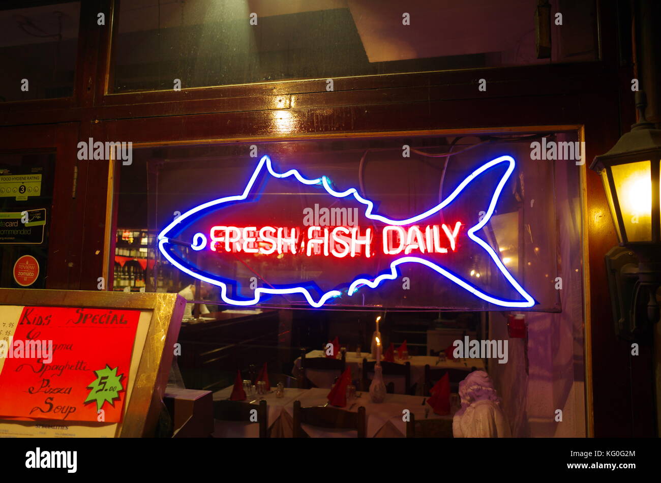 Neon "Fresh Fish Daily" sign in Restaurant window Stock Photo - Alamy