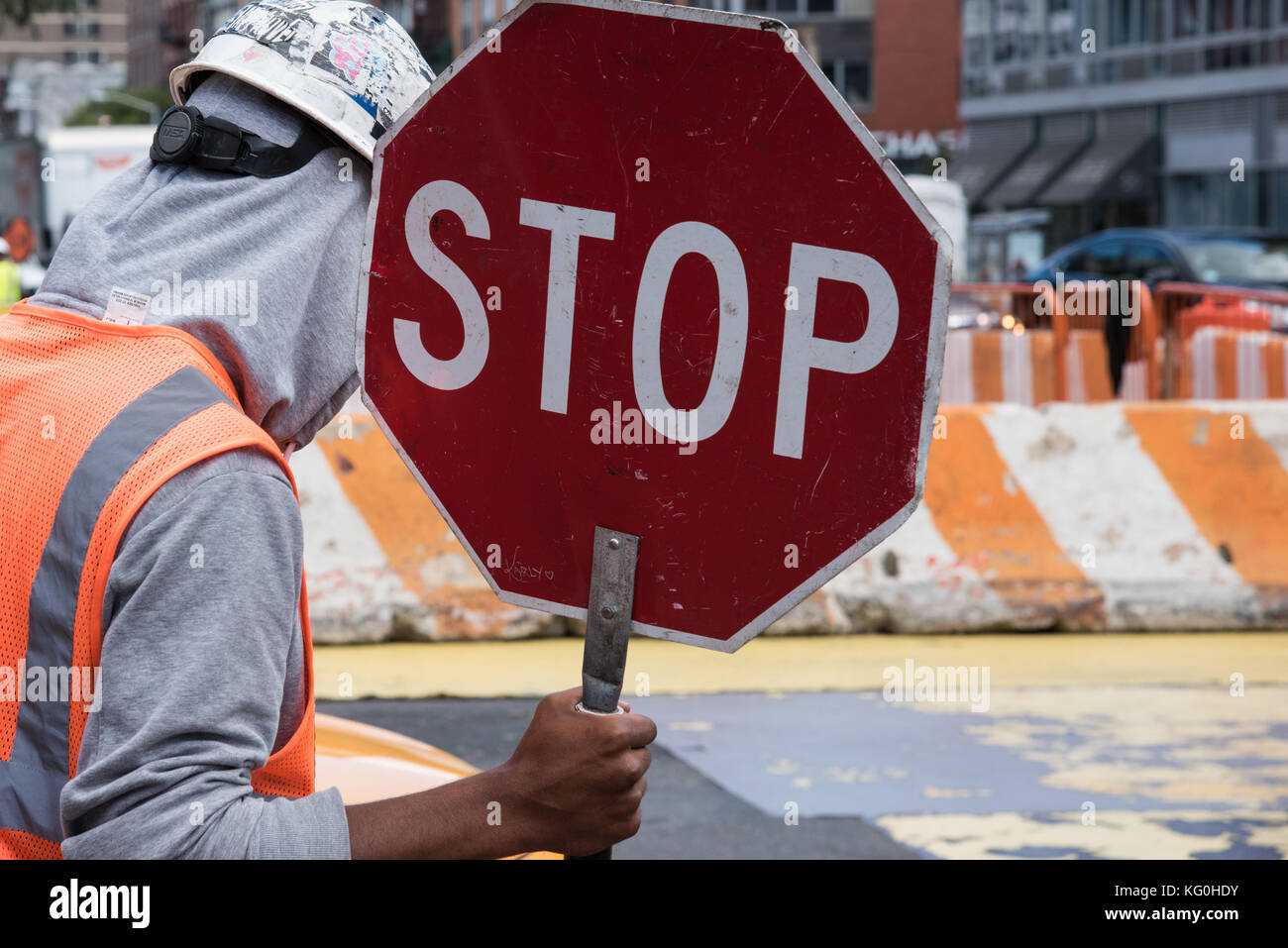 A worker carrying stop sign Stock Photo - Alamy