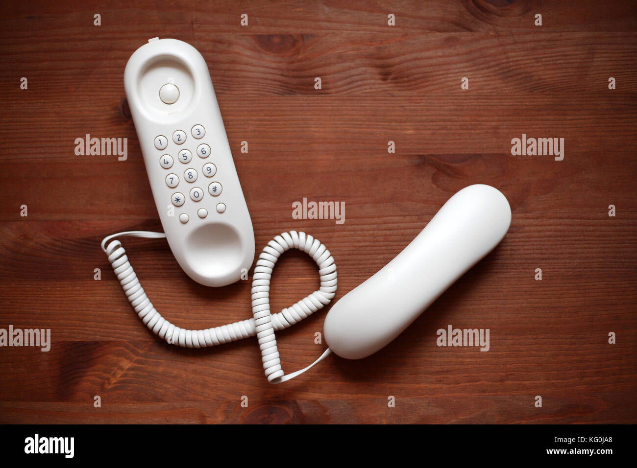 Modern white phone on nice wooden surface Stock Photo - Alamy