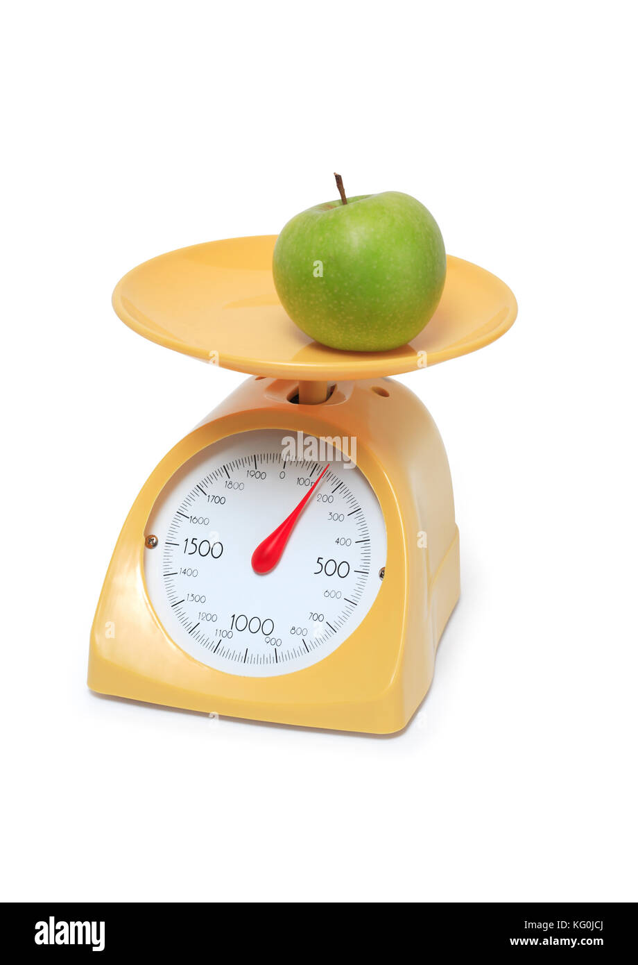 Green apple lying on yellow kitchen scale. Isolated on white background ...