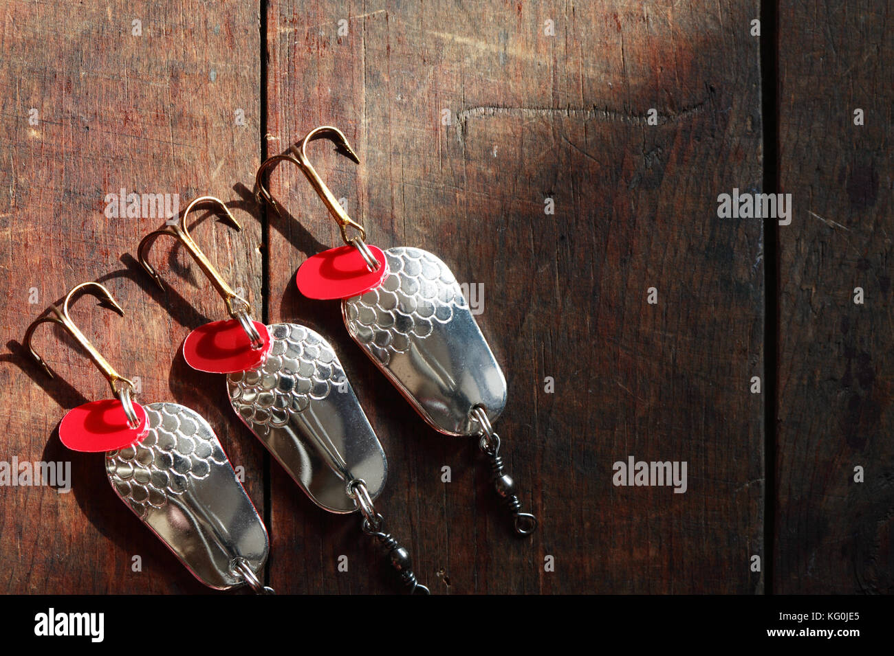 Three spinners lying in a row on wooden surface with copy space Stock ...