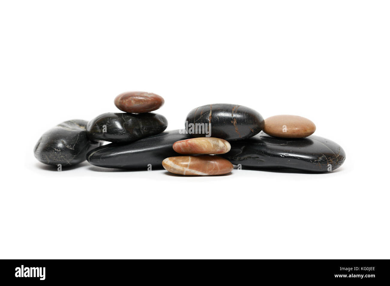 Few stones lying in a row on white background Stock Photo - Alamy