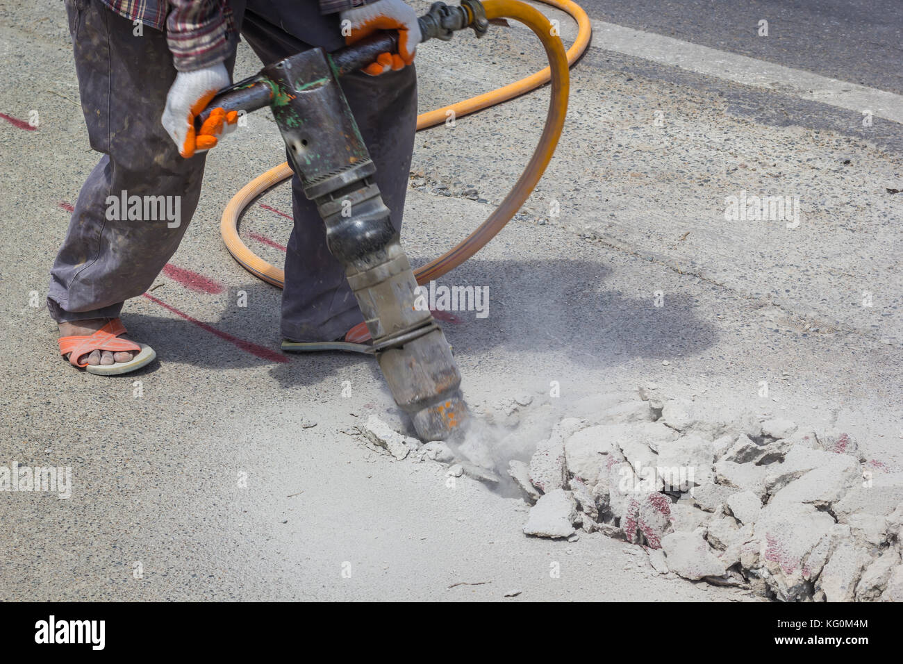 A photo of a man drilling road Stock Photo - Alamy