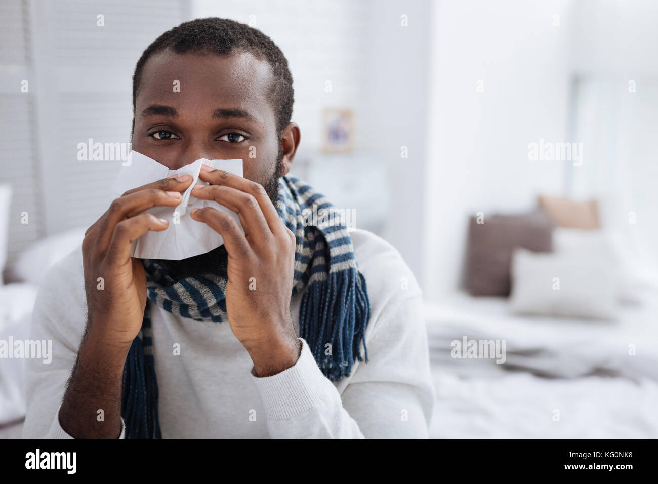 Calm ill man using soft handkerchief at home Stock Photo - Alamy