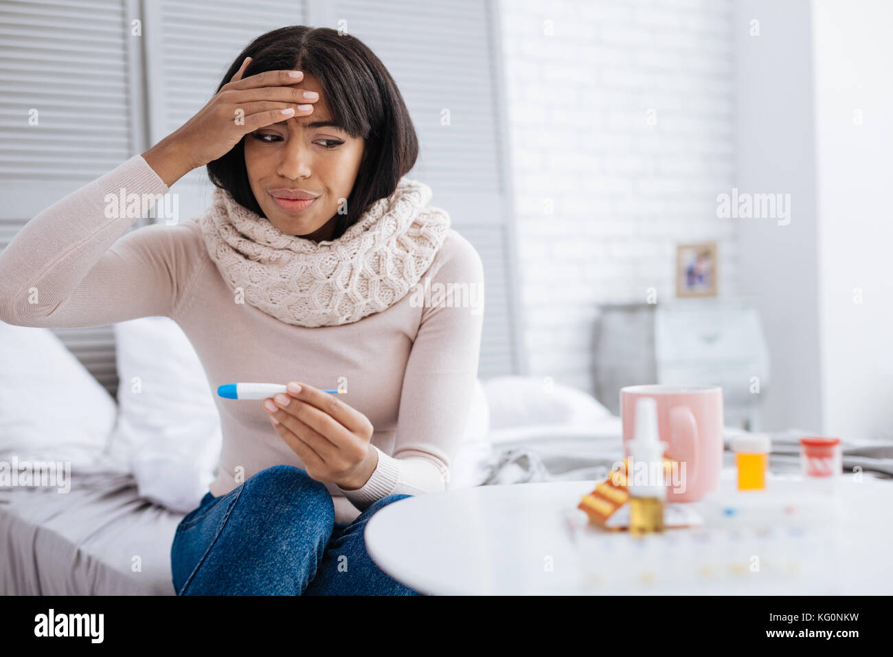 Sick woman upset temperature measurement hi-res stock photography and ...