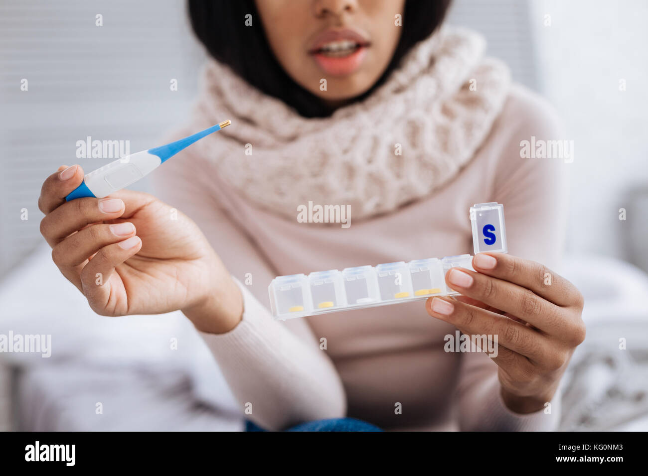Responsible patient opening a special pill box Stock Photo - Alamy