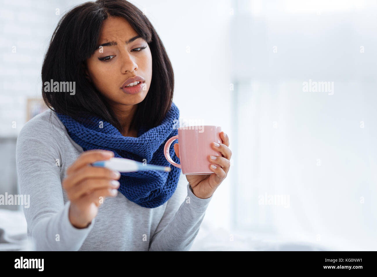 Ill woman noticing small changes in her temperature Stock Photo - Alamy