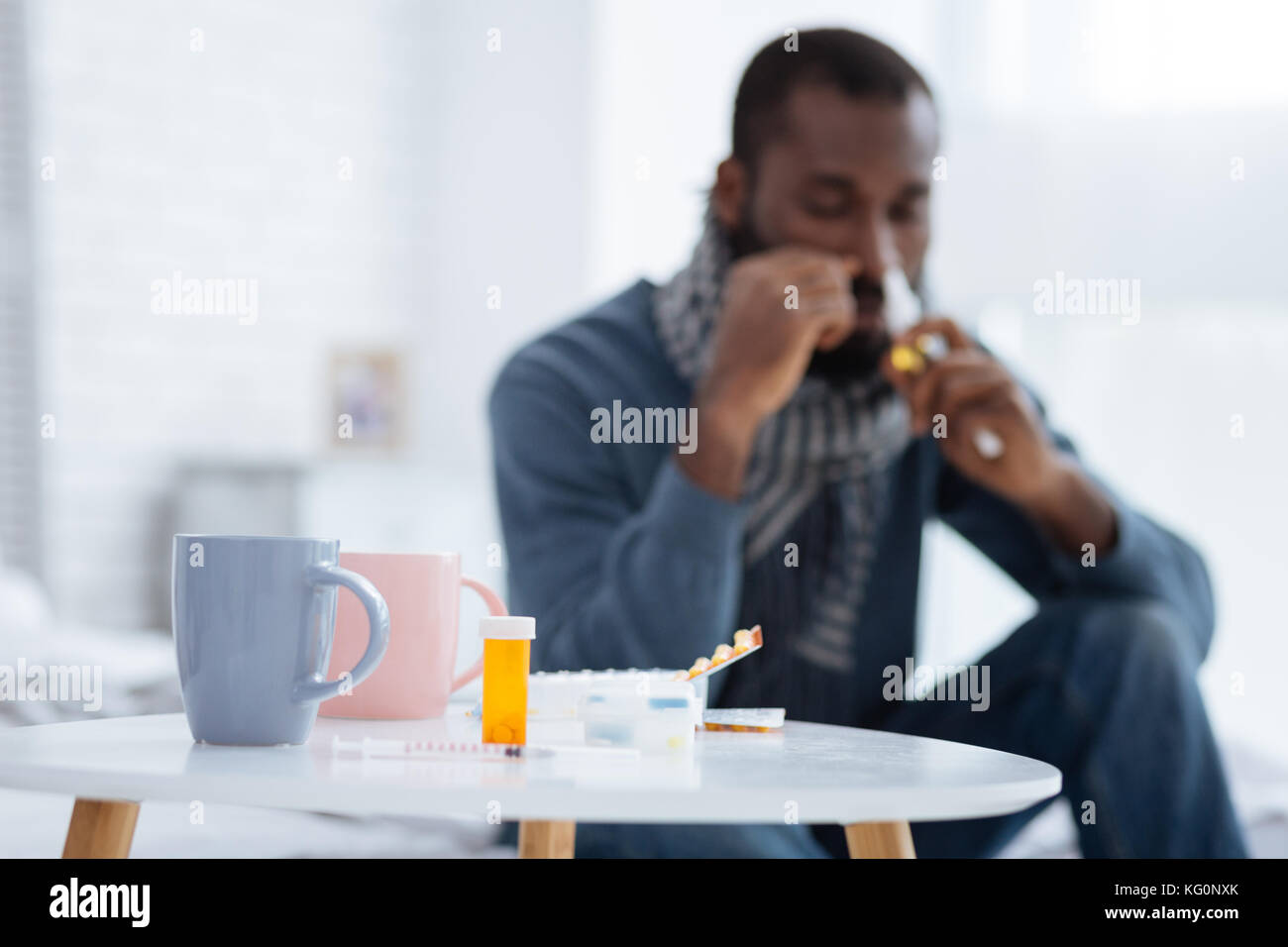 Ill man sitting near table hi-res stock photography and images - Alamy