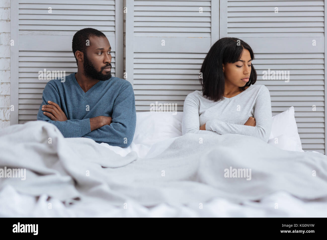 Unhappy young people sitting without talking Stock Photo - Alamy
